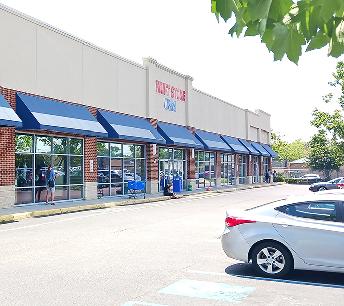 Another angle of the thrift store's exterior shows its prominent position in the shopping center, blue awnings providing a pop of color against the beige.