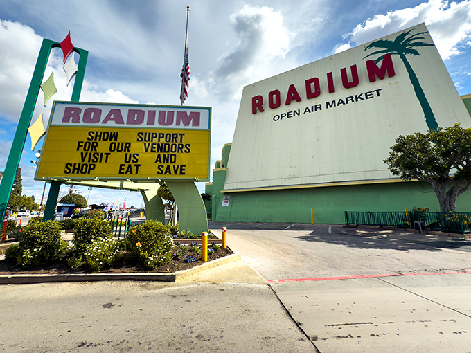 The iconic mint-green entrance to The Roadium stands like a retro beacon of bargain hunting, promising treasures under that classic Southern California sky.