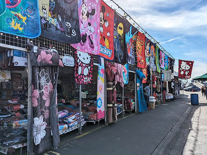 The Santa Fe Springs Swap Meet entrance beckons with a kaleidoscope of colorful blankets and character merchandise. Treasure hunting begins here!