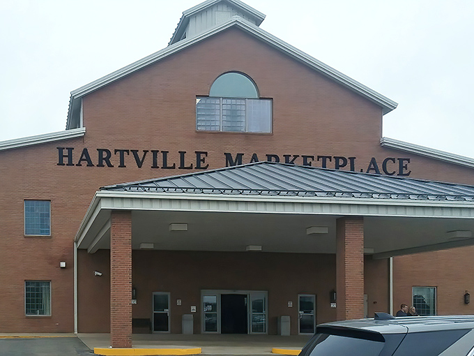 The brick facade of Hartville MarketPlace stands like a cathedral to commerce, promising treasures within that big box stores can only dream about.