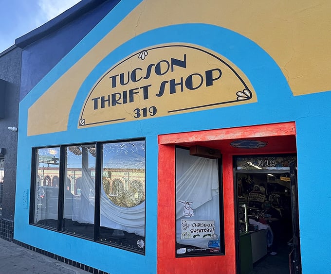 The vibrant turquoise and yellow facade of Tucson Thrift Shop beckons like a desert mirage, promising treasures within its colorful walls.