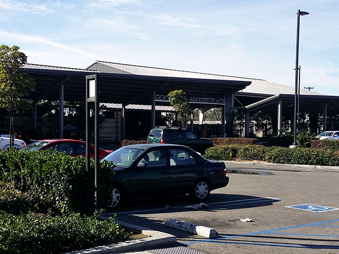 The sprawling exterior of Goodwill Marketplace beckons like a treasure island in a sea of asphalt. Adventure awaits under that industrial canopy.