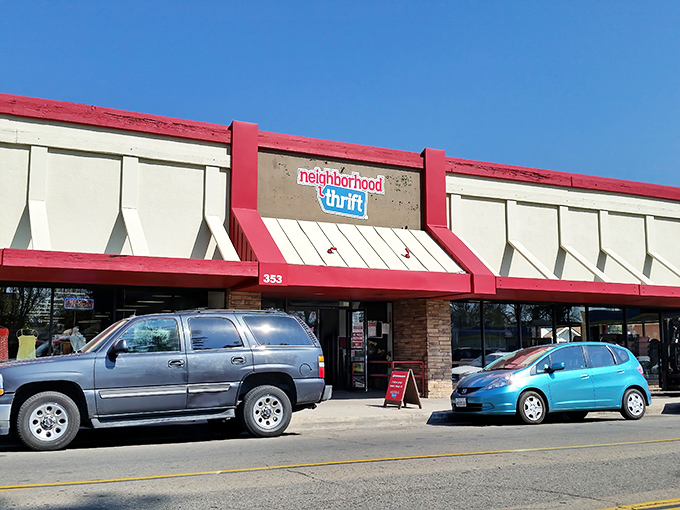 The distinctive red-trimmed facade of Neighborhood Thrift stands out against the Fresno sky, beckoning bargain hunters with promises of hidden treasures.