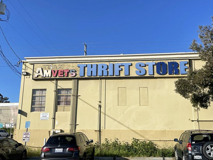 Blue skies frame this thrifter's paradise, where the bold signage promises treasures that would make any bargain hunter's heart skip a beat.