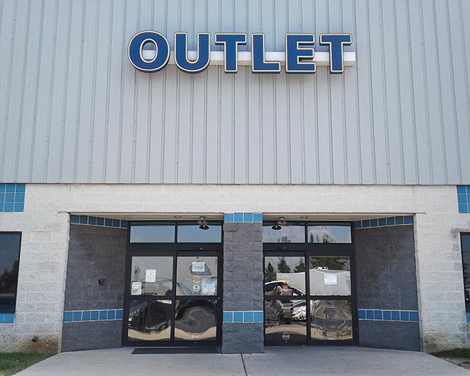 The unassuming exterior of Goodwill Outlet in New Castle &ndash; where treasure hunting adventures begin behind those modest blue-trimmed doors.