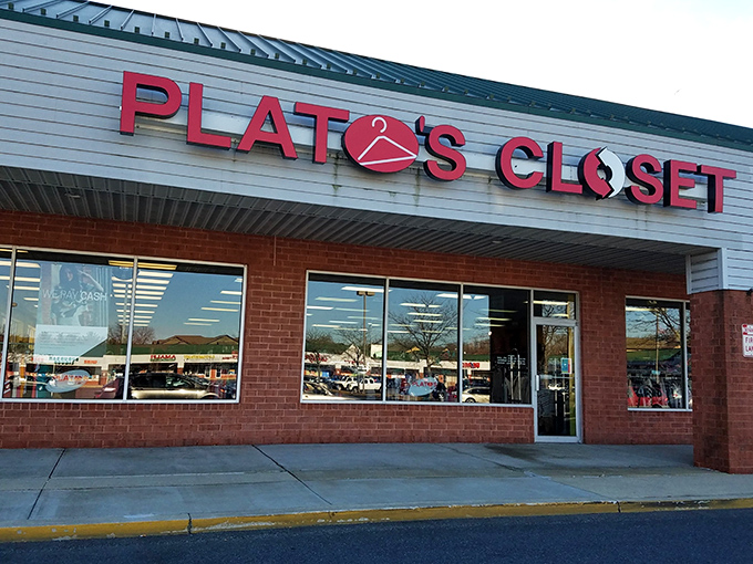 The bright red signage of Plato's Closet beckons like a fashion lighthouse, promising treasure within those brick walls.
