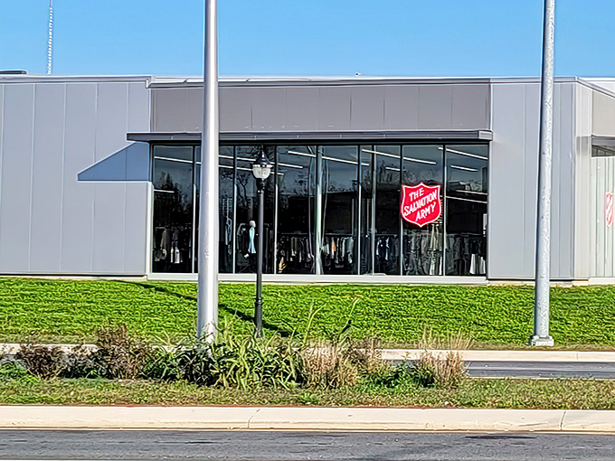The sleek exterior of Wilmington's Salvation Army Thrift Store beckons with its iconic red shield logo&mdash;a modern treasure chest disguised as a retail space.