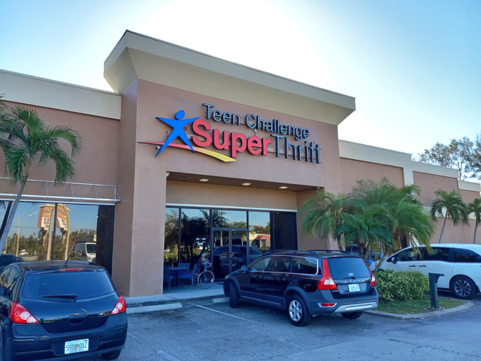 The pink stucco exterior of Teen Challenge SuperThrift stands like a beacon of bargain possibilities, palm trees included at no extra charge.