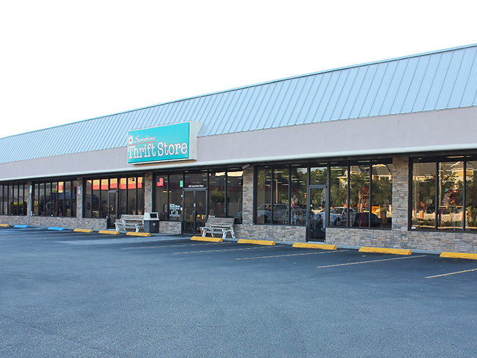 The distinctive blue roof and turquoise sign of Sunshine Thrift Store beckons bargain hunters like a retail oasis in the Florida heat.