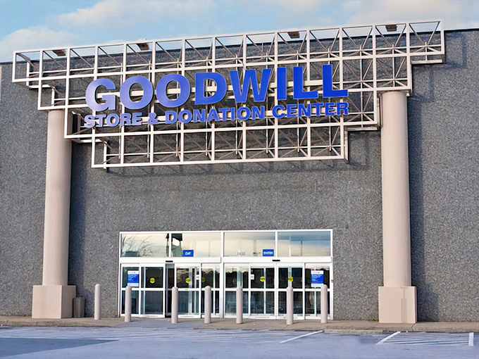 The blue Goodwill sign stands like a beacon of bargain hope against the gray building&mdash;retail therapy without the retail prices.