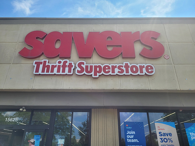 The bold red Savers sign beckons like a lighthouse for bargain hunters. This isn't just shopping&mdash;it's a treasure hunt with fluorescent lighting.