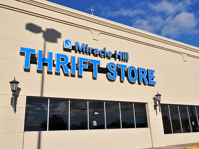 Sunshine casts playful shadows against the bright blue lettering, nature's spotlight on this community institution where secondhand becomes first-rate.