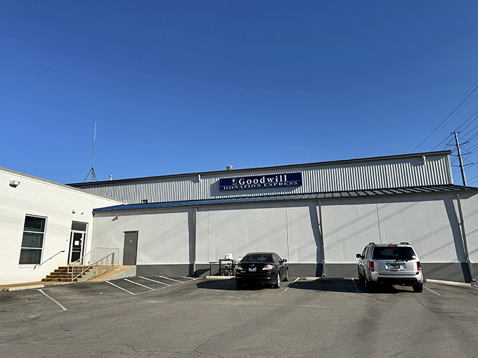 The blue awning and bright green "Outlet" sign beckon treasure hunters like a siren call to bargain paradise.