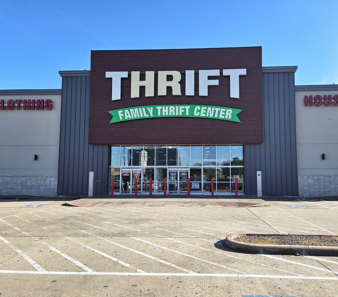 The brown and gray facade of Family Thrift Center stands like a temple to bargain hunters, its green banner promising treasures within.