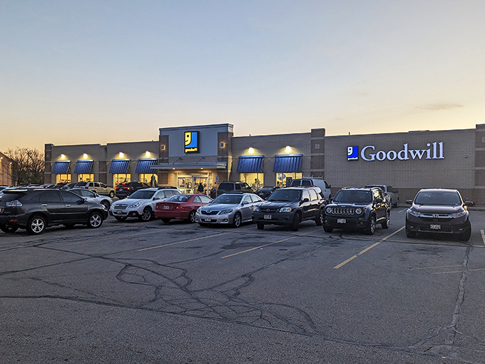The unassuming exterior of Milwaukee's treasure trove beckons at dusk, blue awnings signaling the thrifting adventure that awaits inside.