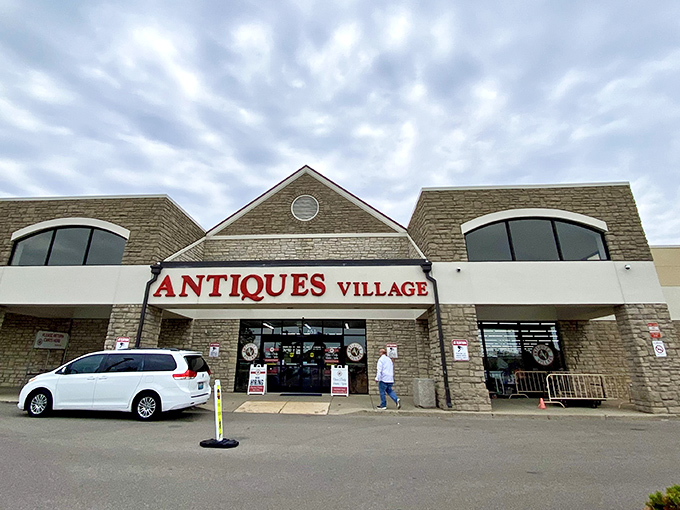 The stone facade of Antiques Village welcomes treasure hunters with its bold red signage&mdash;a portal to yesterday that promises discoveries around every corner.