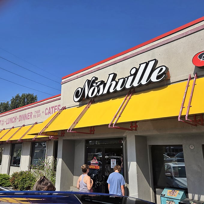 That iconic script against the yellow backdrop isn't just a sign&mdash;it's a portal to a world where New York deli meets Southern hospitality.