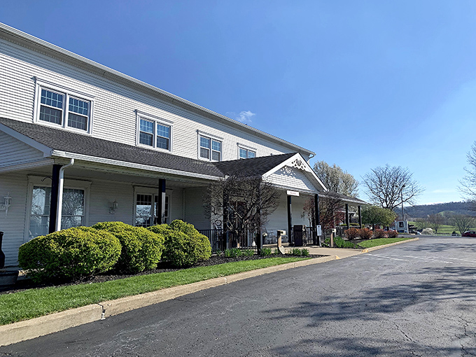 The pristine white exterior of Amish Door Restaurant stands like a welcoming beacon against Ohio's blue skies, promising comfort food that transcends time.