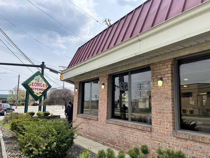 As dusk settles, George's Kitchen's warm glow promises refuge from the day&mdash;a burgundy-roofed sanctuary where hungry souls find solace in homestyle cooking.