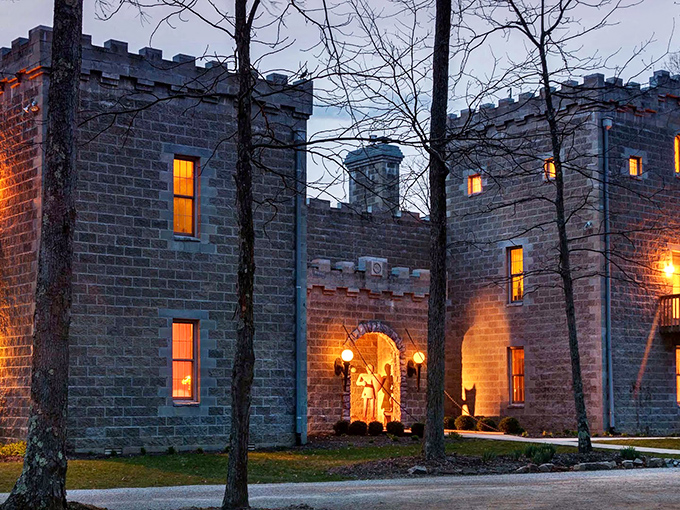 Twilight transforms Ravenwood Castle into a magical realm, its stone walls aglow with warm light that beckons weary travelers into this medieval fantasy tucked away in Ohio's forests.