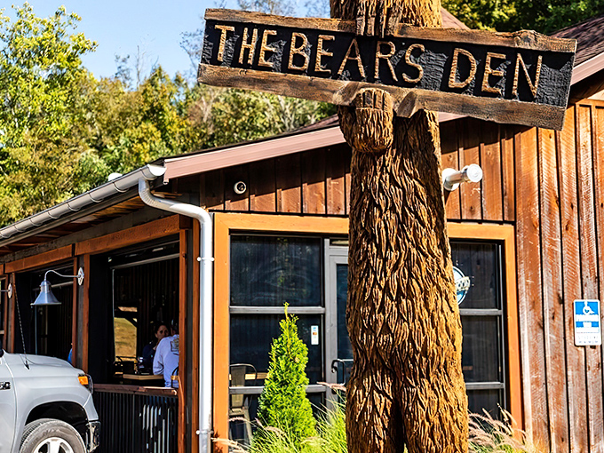 The wooden bear guardian stands tall, welcoming hungry travelers to this rustic hideaway. Nature and comfort converge at Cambridge's best-kept culinary secret.