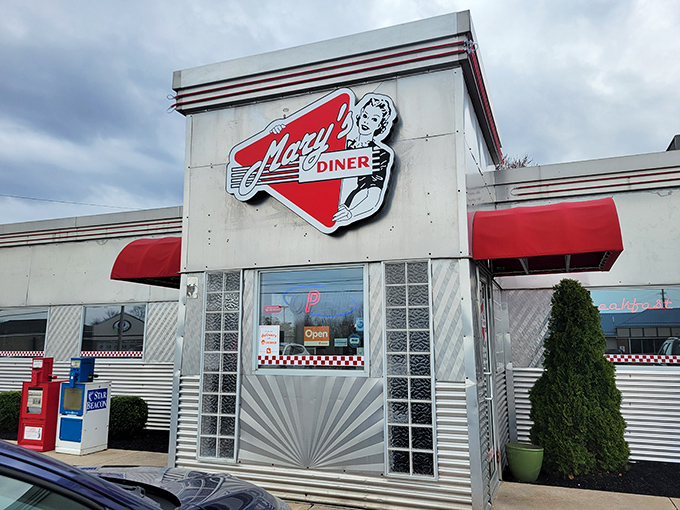 The iconic red and white exterior of Mary's Diner stands like a time capsule in Geneva, Ohio, complete with vintage signage that promises nostalgic delights within.