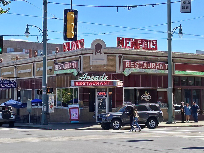 The iconic corner presence of The Arcade Restaurant stands as Memphis royalty, where neon promises and brick walls have witnessed decades of hungry pilgrims.
