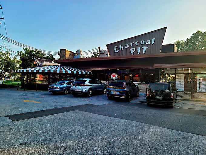 That distinctive blue-and-white striped awning has sheltered generations of diners heading in for their comfort food fix&mdash;Delaware's culinary time machine awaits beneath that iconic sign.