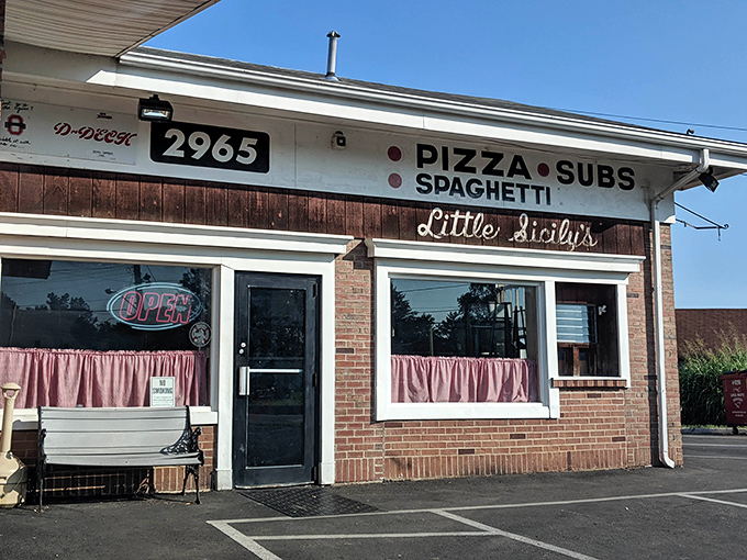 Little Sicily's unassuming brick exterior is like that friend who doesn't brag but always delivers. Those pink curtains have witnessed decades of pizza perfection. 