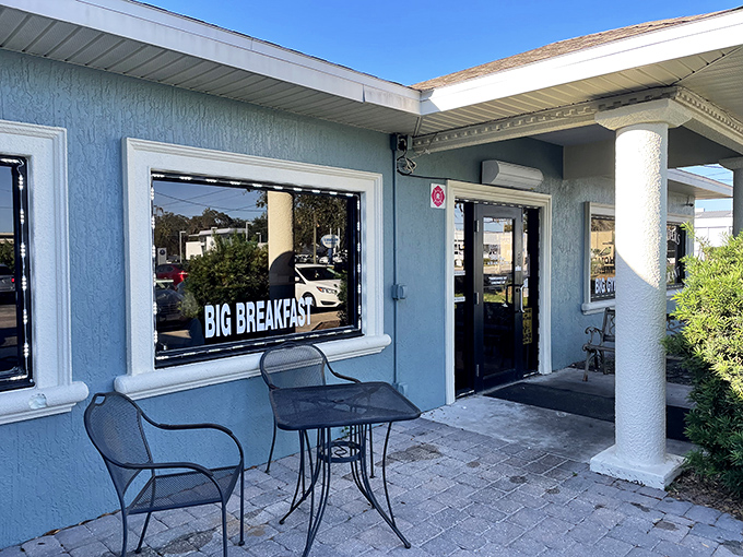 The simple blue exterior whispers modesty, but inside waits a diner where big breakfasts earn even bigger loyalties.