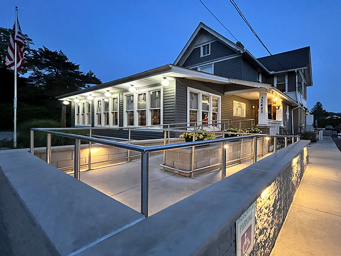 Jake's On Lake glows with twilight charm, its welcoming patio and classic blue siding promising lakeside comfort that feels like coming home.