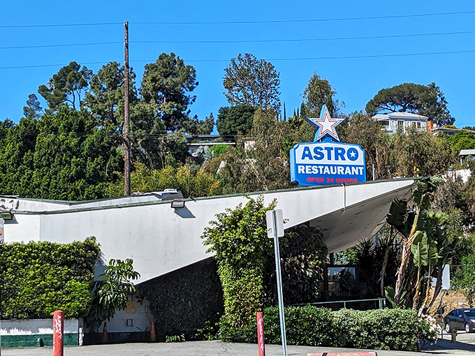 The iconic blue star sign beckons hungry travelers like a mid-century lighthouse promising comfort food and endless coffee refills.