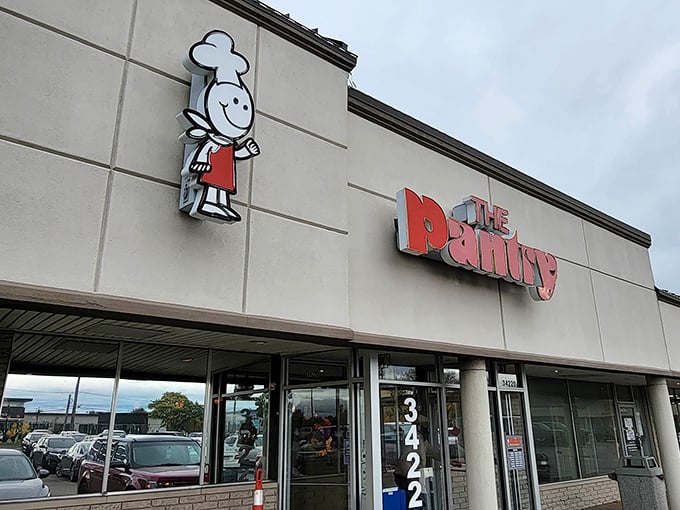 The cheerful chef logo welcomes hungry patrons to The Pantry, where breakfast dreams come true and belt notches go to die.