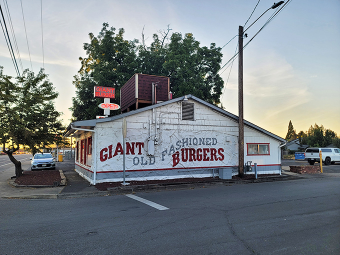 The white building with bold red lettering stands as a time capsule of American dining. No frills, just the promise of burger perfection.