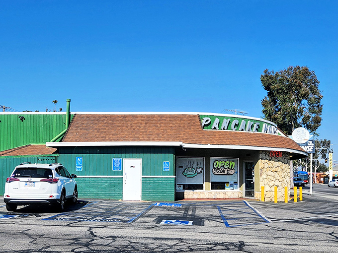 That stone facade and vintage sign whisper promises of breakfast done right, no fancy frills needed.