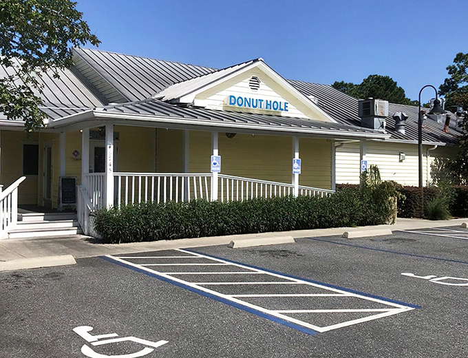 The cheerful yellow exterior of Donut Hole beckons like a breakfast lighthouse on Florida's coast, promising delicious refuge from ordinary morning meals.