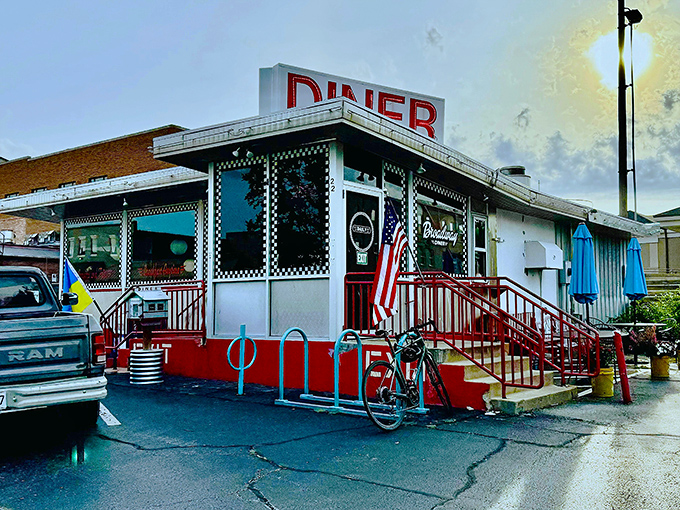 The classic American diner silhouette that promises comfort food salvation, complete with that iconic red trim and patriotic flair.