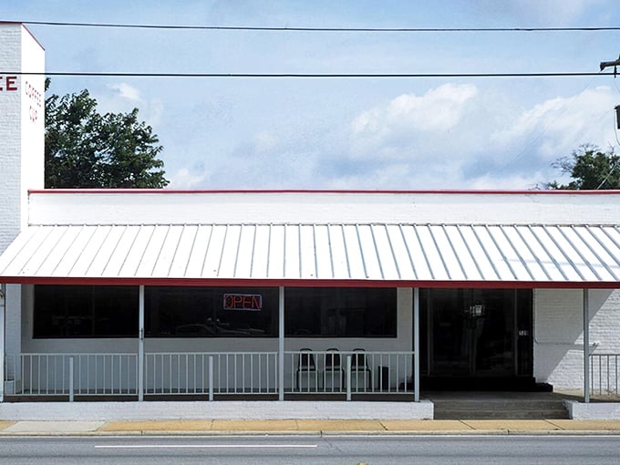 The white brick exterior with its classic red awning isn't trying to be retro &ndash; it's the real deal, standing proudly since 1945 in Pensacola's morning landscape.