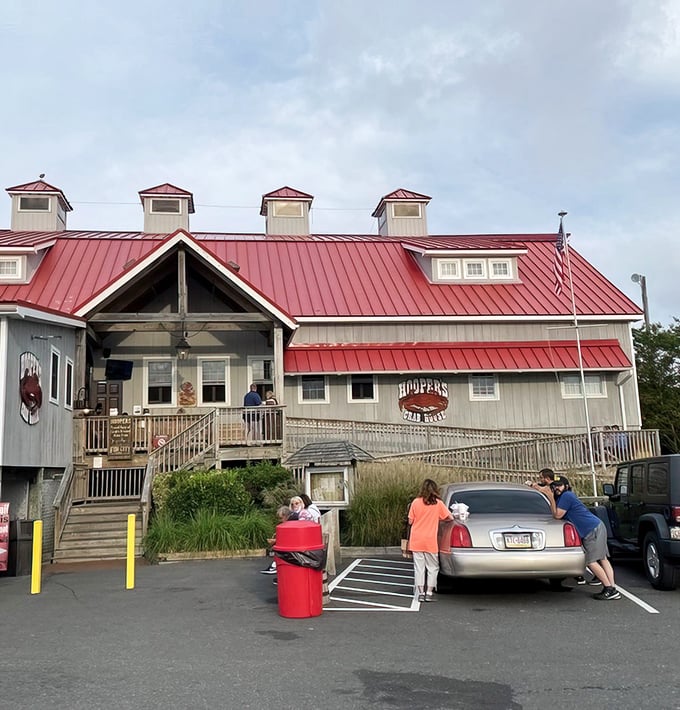 The iconic red-roofed haven of seafood dreams stands proudly against the Maryland sky, beckoning hungry pilgrims with its siren call of steamed crabs.