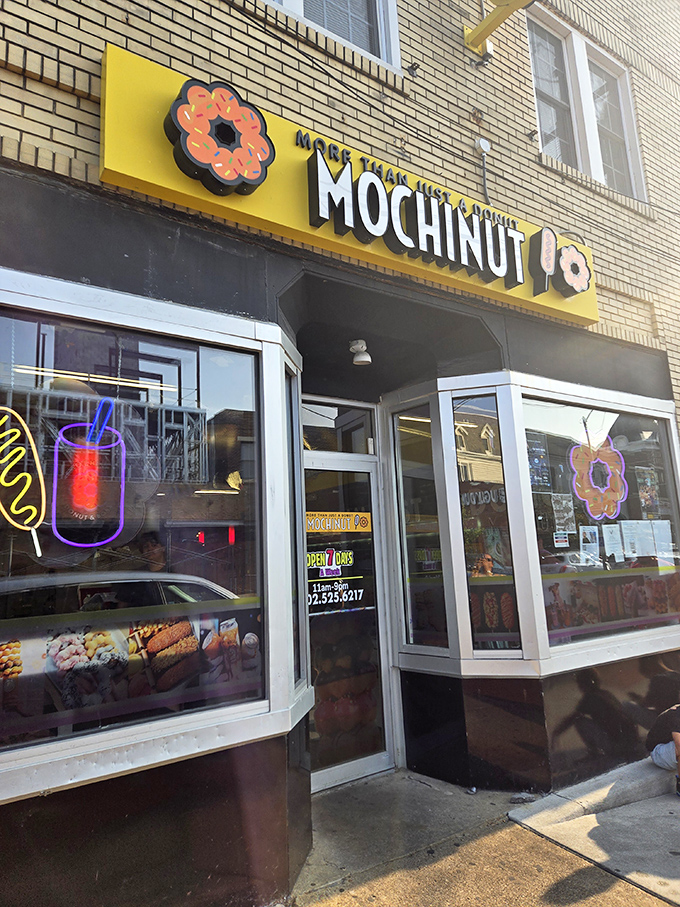 The bright yellow Mochinut storefront stands out like a beacon of sweetness on Newark's Main Street, promising delicious adventures within.