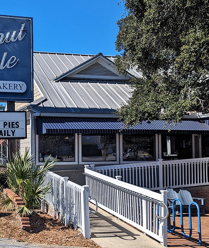 The iconic blue-trimmed exterior of Donut Hole beckons like a siren song to hungry travelers. That white picket fence isn't just charming&mdash;it's crowd control for the breakfast rush!