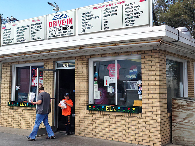 A glimpse of El's brick exterior, where hungry patrons exit with that "I just found burger nirvana" glow. No fancy frills, just food worth the drive.