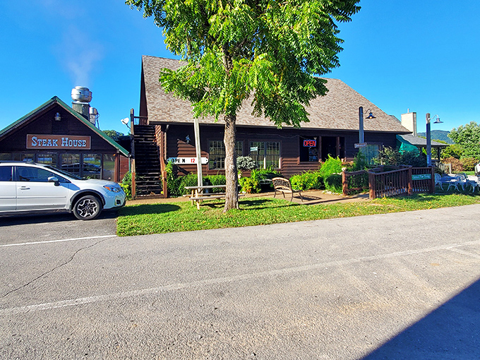 The rustic log cabin exterior of Trailhead Steak & Trout beckons hungry travelers like a carnivorous siren song in the Tennessee hills.