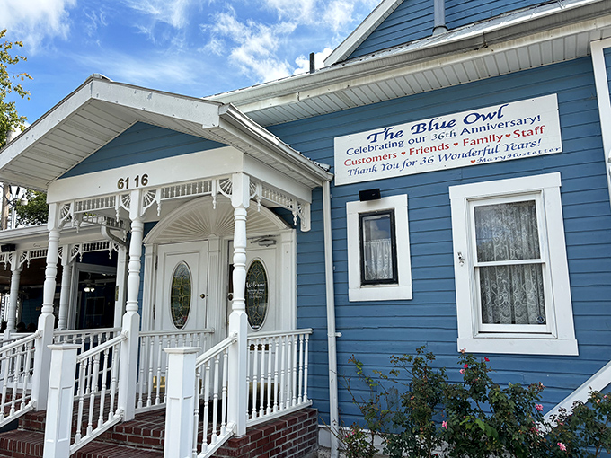 The charming blue clapboard exterior welcomes visitors like an old friend, complete with white trim and a front porch that practically whispers "come sit a spell."