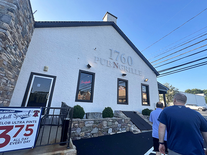The stone-faced exterior of 1760 Pub N Grille stands like a culinary fortress in Trexlertown, promising comfort food treasures within its rustic walls.