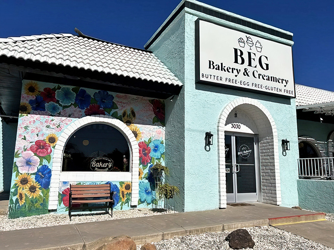 The turquoise oasis of BEG Bakery & Creamery beckons with its vibrant floral mural, promising sweet treasures that defy dietary restrictions with delicious rebellion.