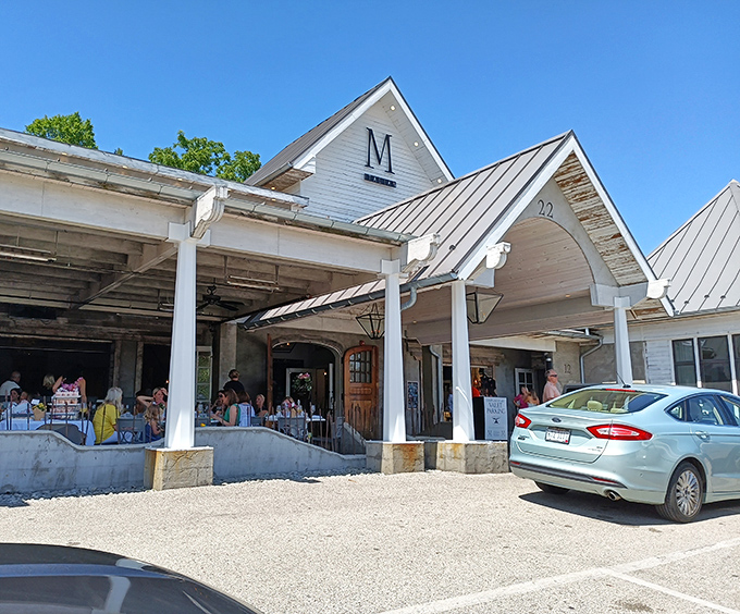 The distinctive white exterior of M Italian stands like a culinary beacon in Chagrin Falls, inviting hungry travelers with its charming farmhouse-inspired architecture and welcoming porch.