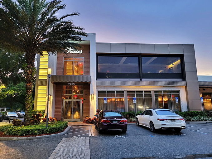 The modern exterior of Del Frisco's stands like an oasis of sophistication amid Orlando's lush landscaping. Carnivore paradise awaits.