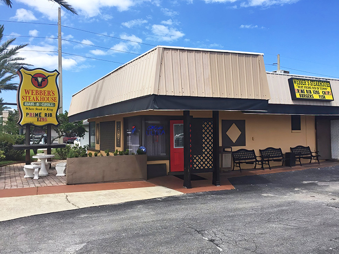 By day, this unassuming beige building might not turn heads, but locals know the yellow sign means serious business when it comes to prime rib.