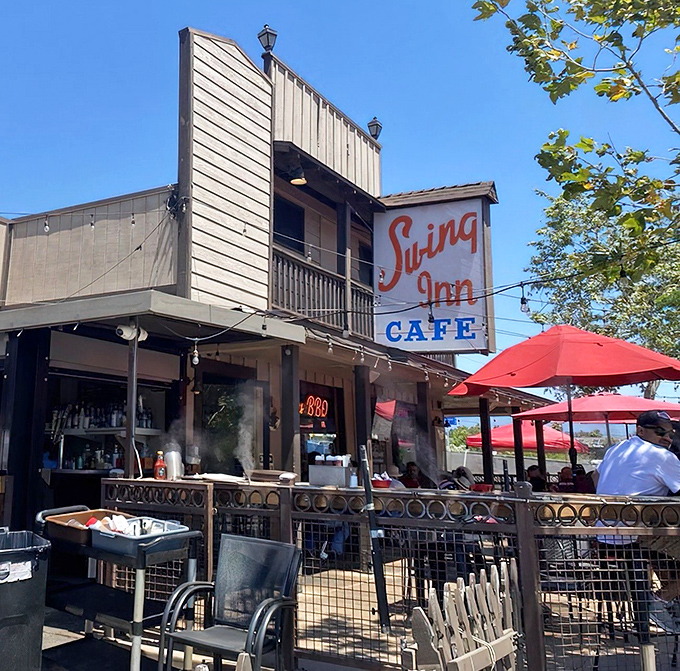 The Swing Inn's iconic facade stands proudly in Old Town Temecula, its vintage sign and wooden balcony promising comfort food that transcends time.